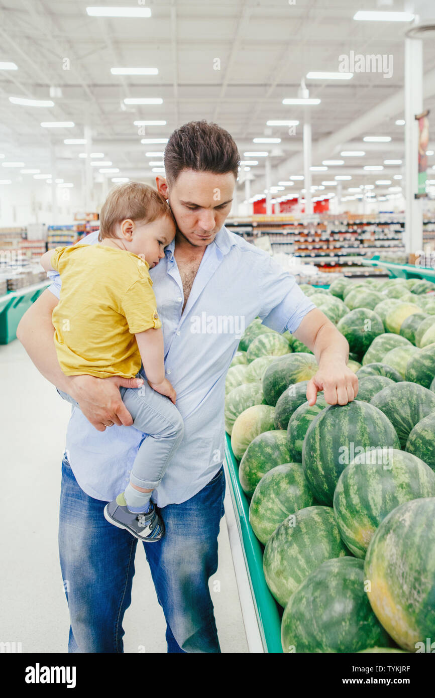 Caucasian father dad in grocery store shopping buying food fresh fruits ...