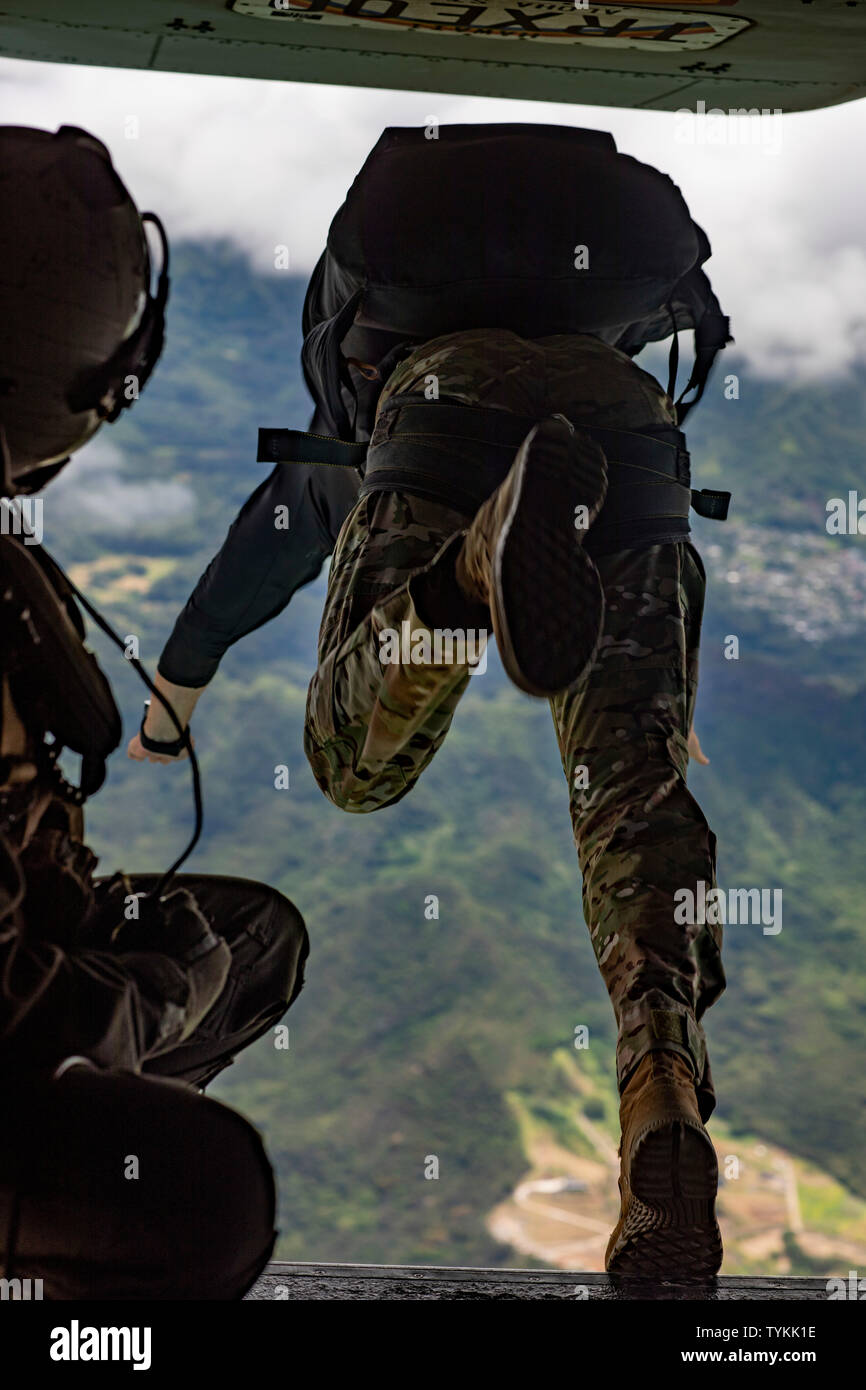 A U.S. Service member with Special Operation Command, Pacific, jumps ...