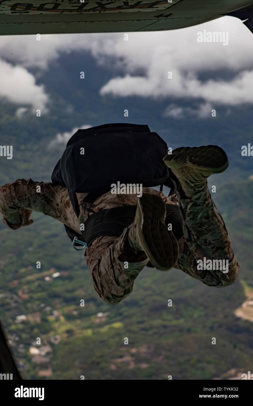 A U.S. Service member with Special Operation Command, Pacific, jumps ...