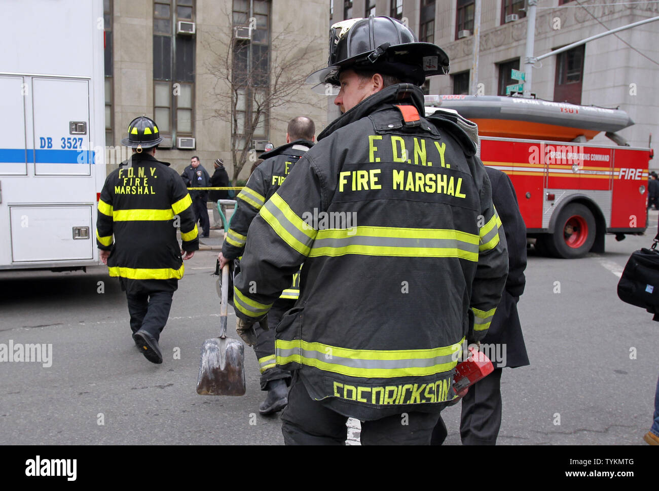 Fire Marshals enter a building after a fire broke out in the basement ...
