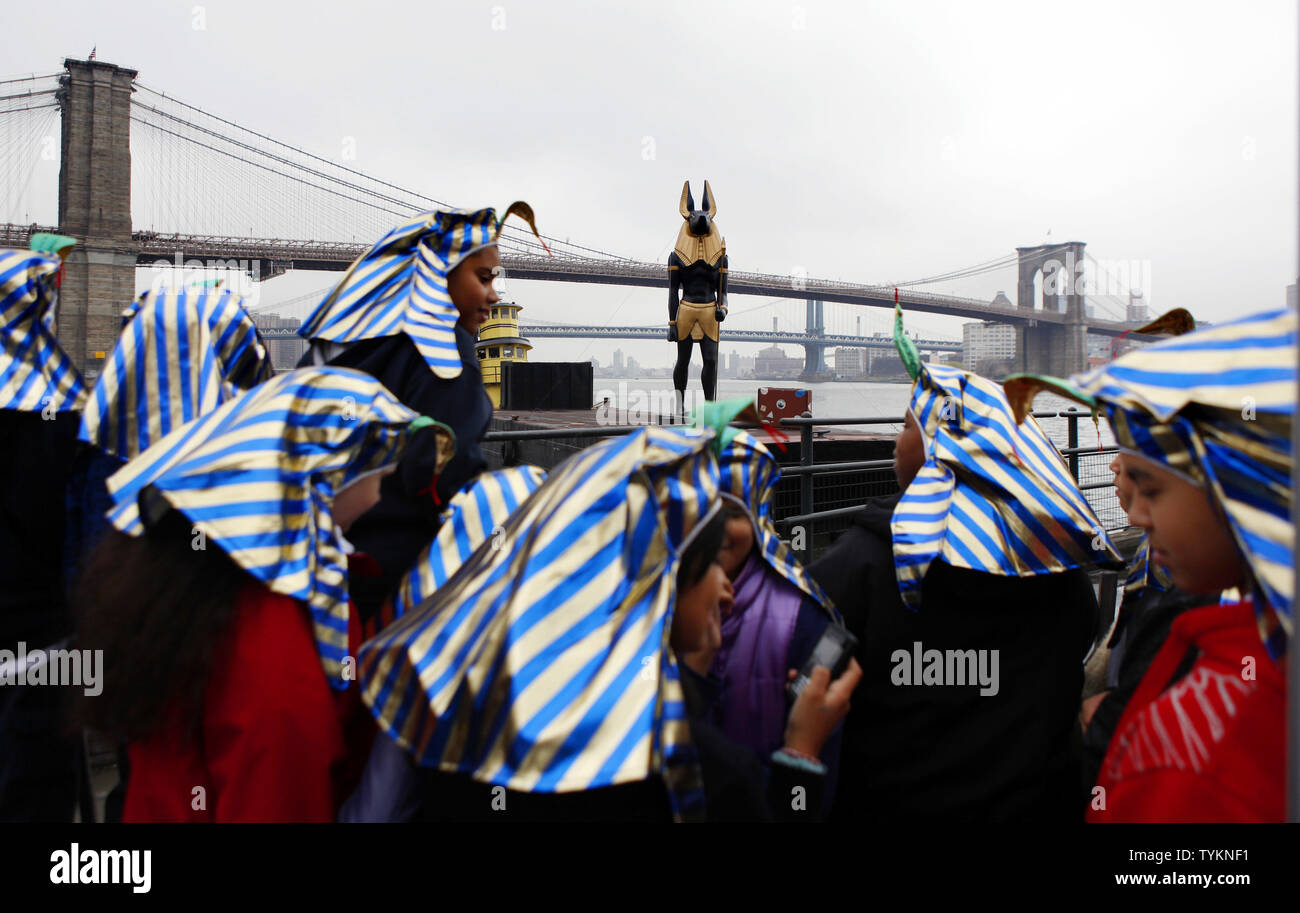 Public School Children wearing Tut hats watch a 25-foot tall, 7 ton ...