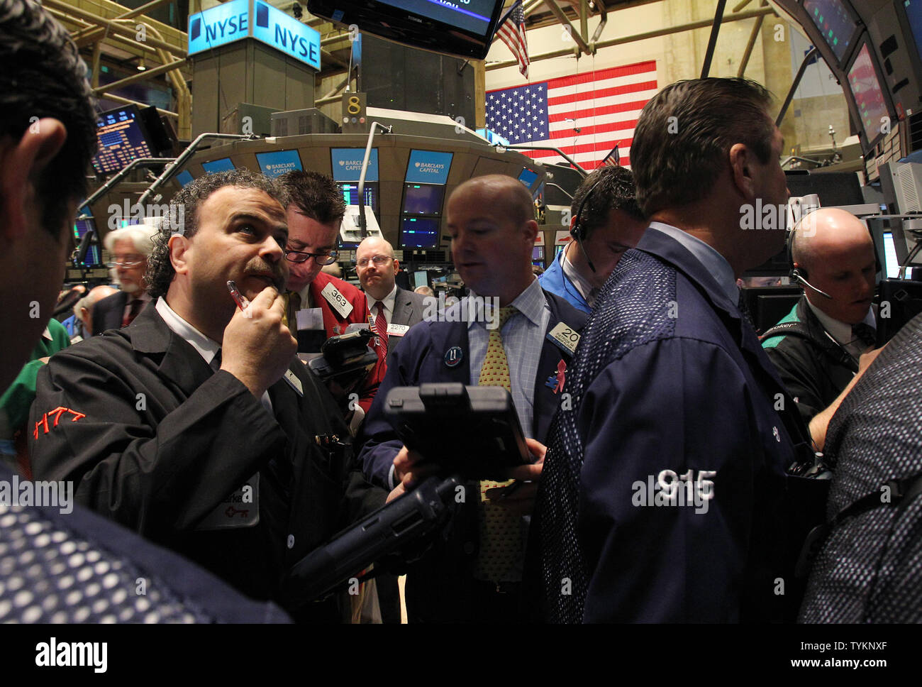 Wall Street employes are busy working moments before the opening bell ...