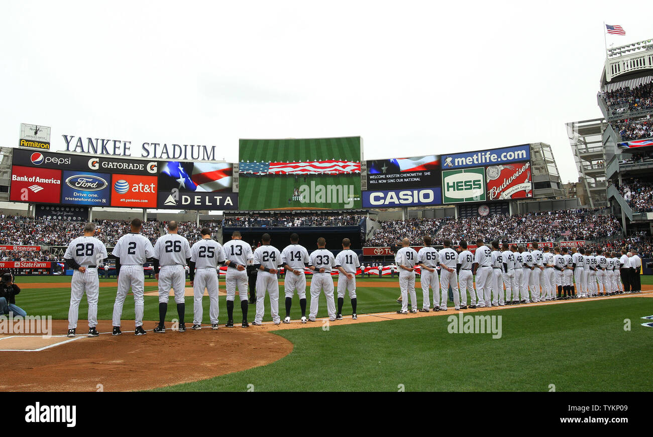 The New York Yankees stand on the first base line for the National ...