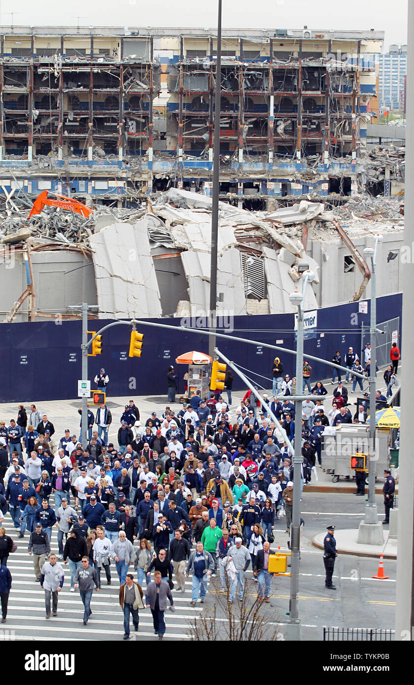 Crowds of fans cross the street near the torn down old Yankee Stadium ...