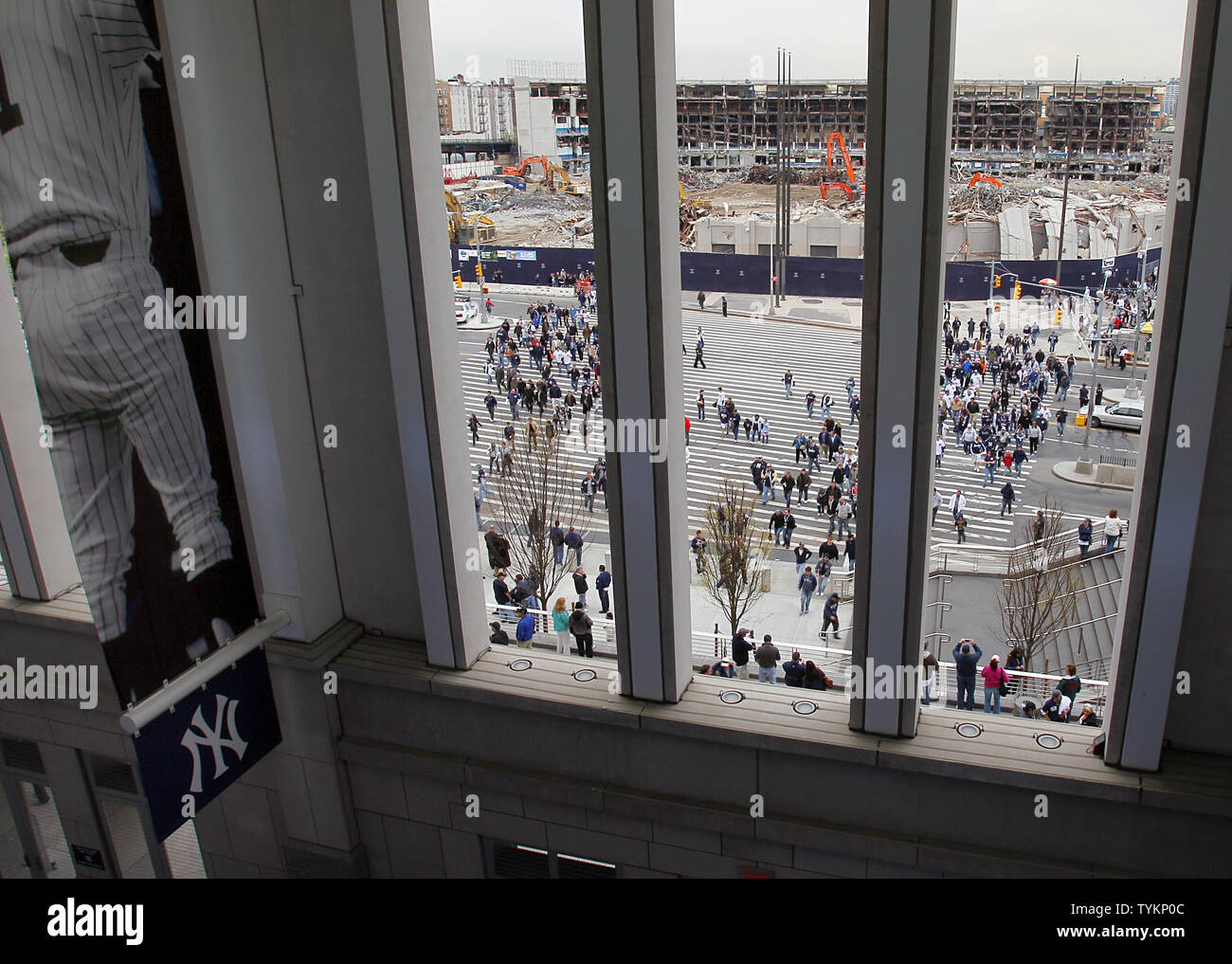 Crowds of fans cross the street near the torn down old Yankee Stadium ...