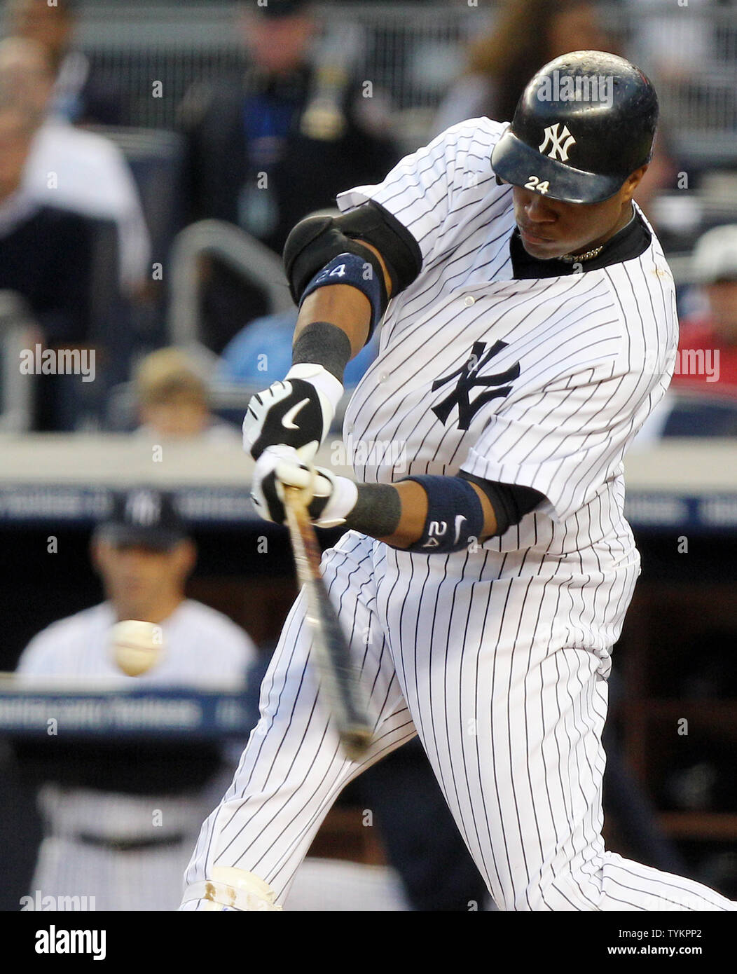 New York Yankees Robinson Cano hits an RBI single in the first inning ...
