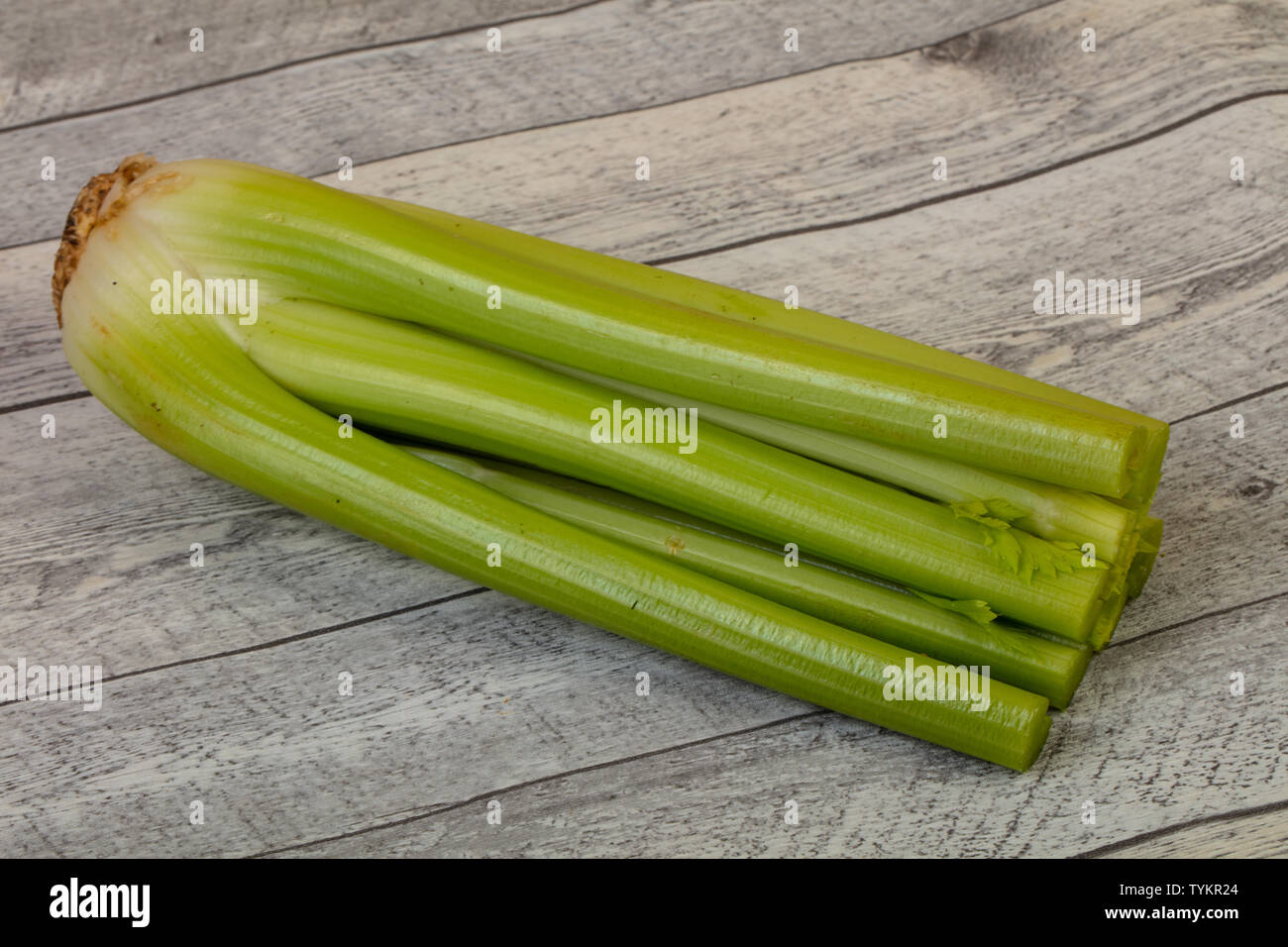 Organic food - celery sticks over wooden background Stock Photo - Alamy