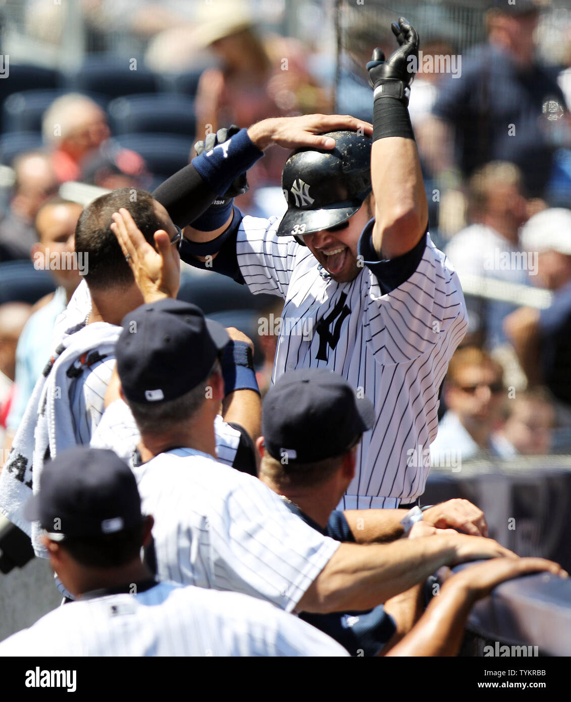 New York Yankees Nick Swisher reacts with teammates after hitting a ...