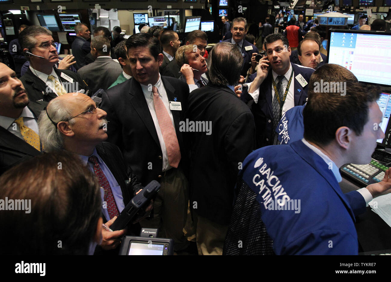 Wall Street employes are busy working moments after the opening bell on ...