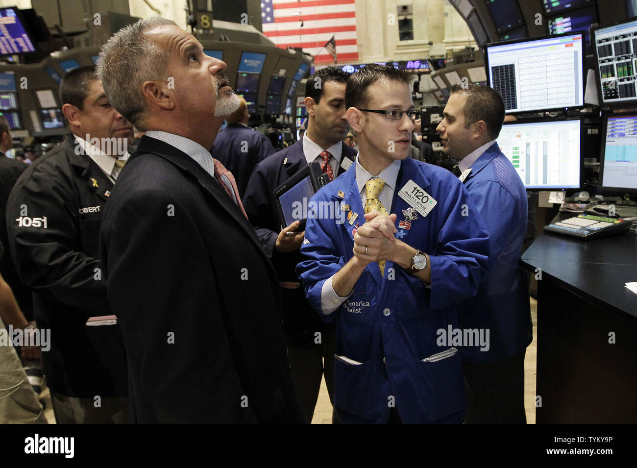 Wall Street employees are busy working moments before the opening bell ...