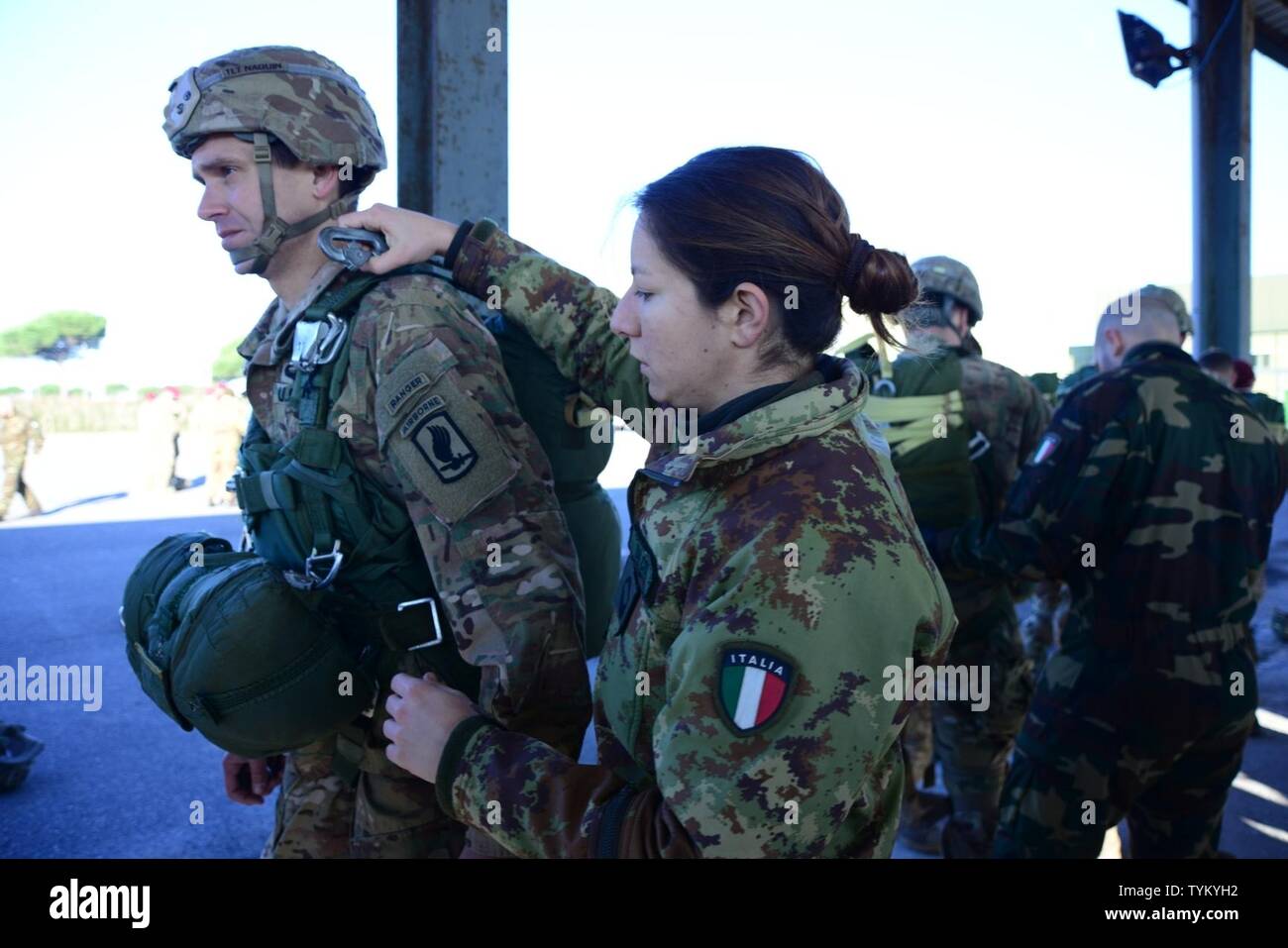 An Italian Army Folgore Brigade soldier inspects the equipment of an U ...