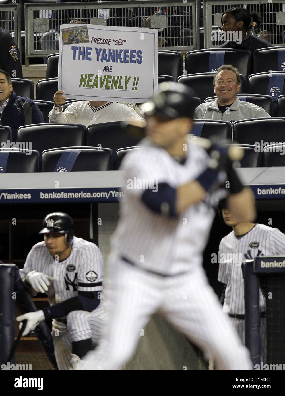 Fans hold up signs remembering long time Yankee fan Freddie Sez as the ...