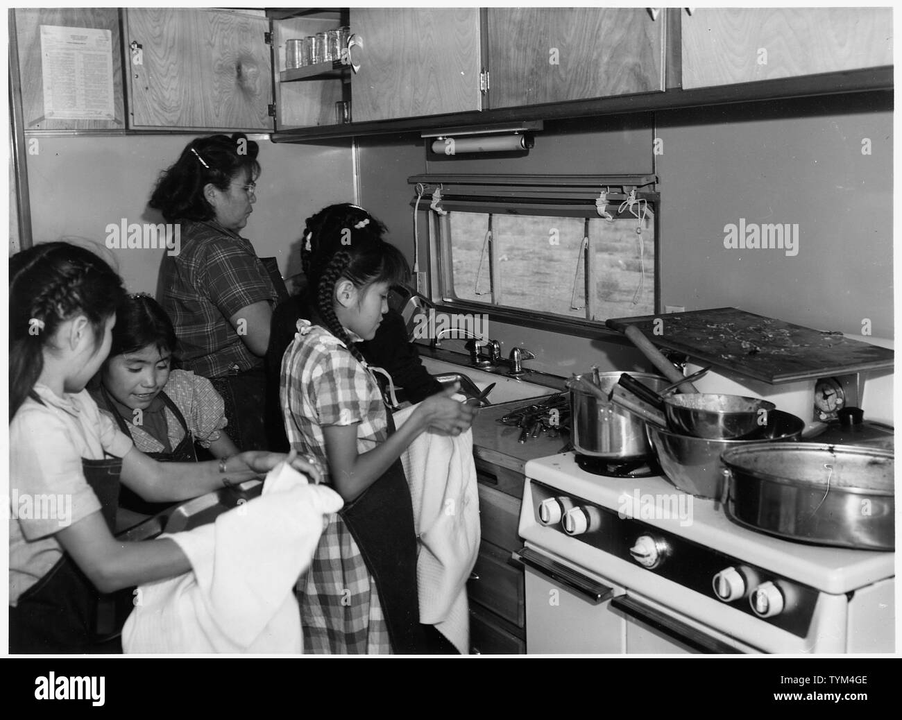[Teacher with students learning sanitary kitchen practices in day ...
