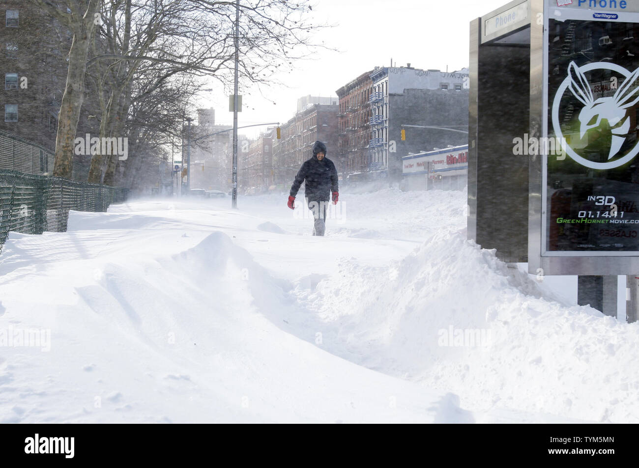 A pedestrian walks up First Avenue through the snow after a blizzard ...