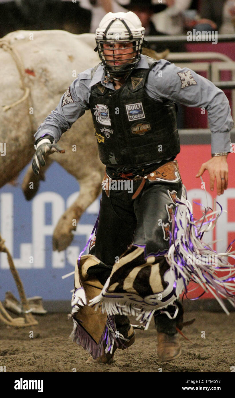 Shane Proctor runs away from his bull after being tossed during the ...