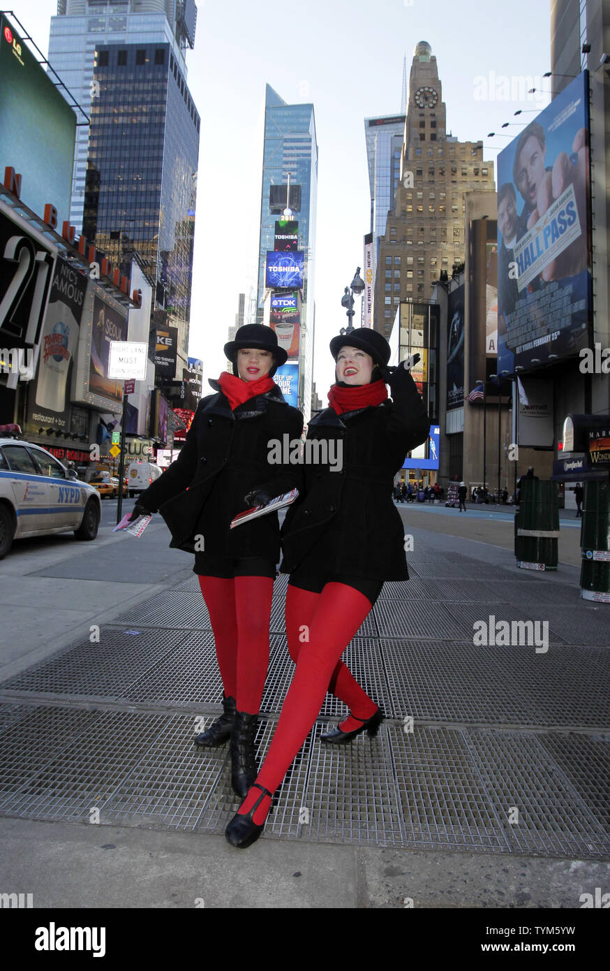 Katy Irwin and Mysteea Saunders dance while handing out flyers for the ...