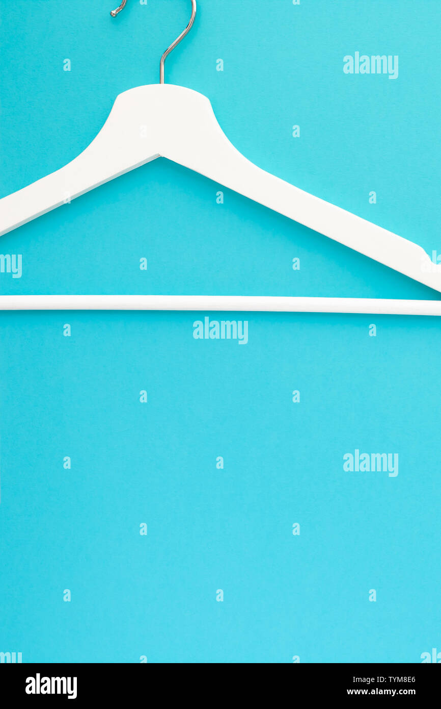Creative top view flat lay white wooden hangers isolated bold blue ...