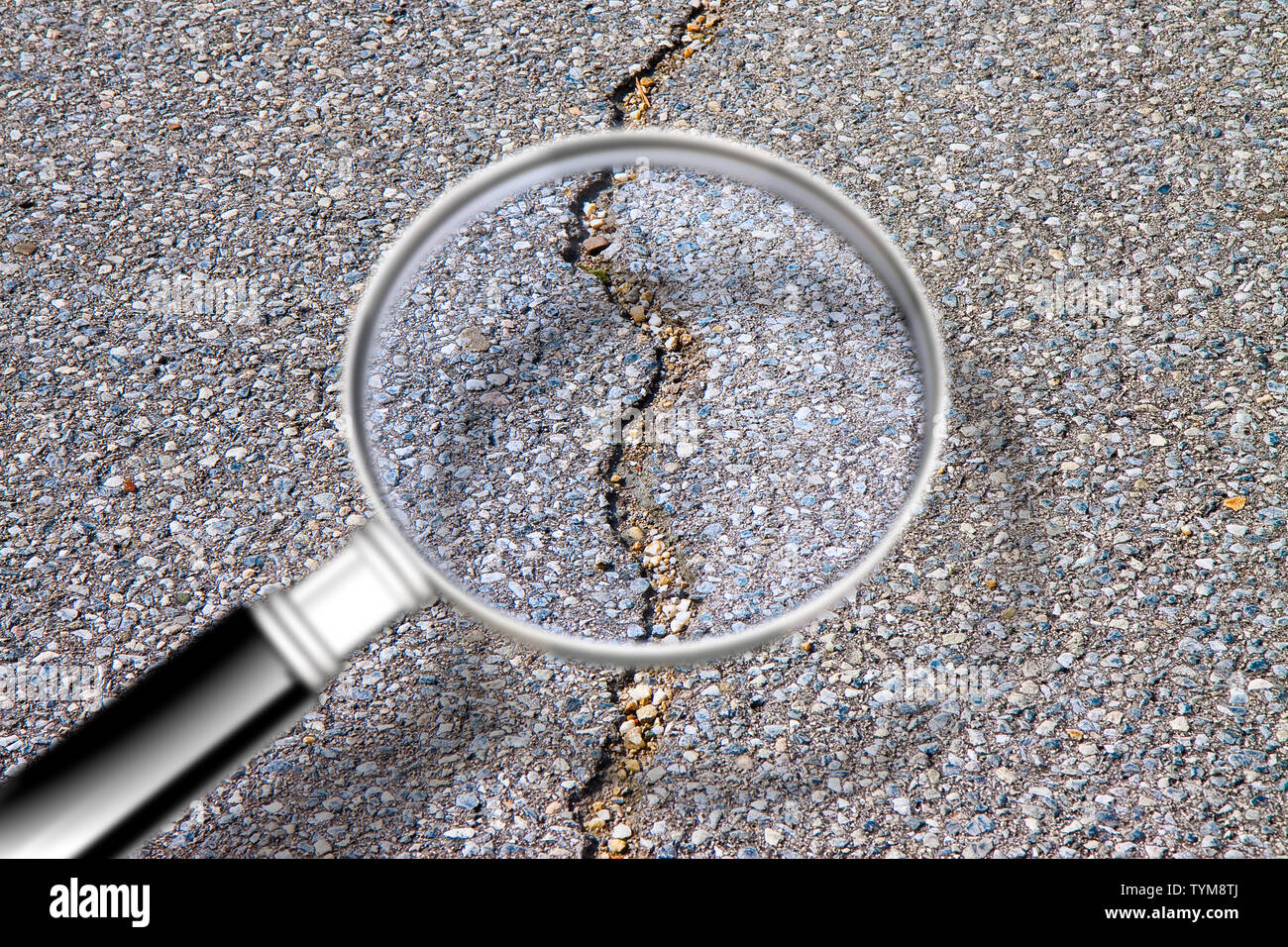 Cracked asphalt road damaged after a structural failure - Concept image ...