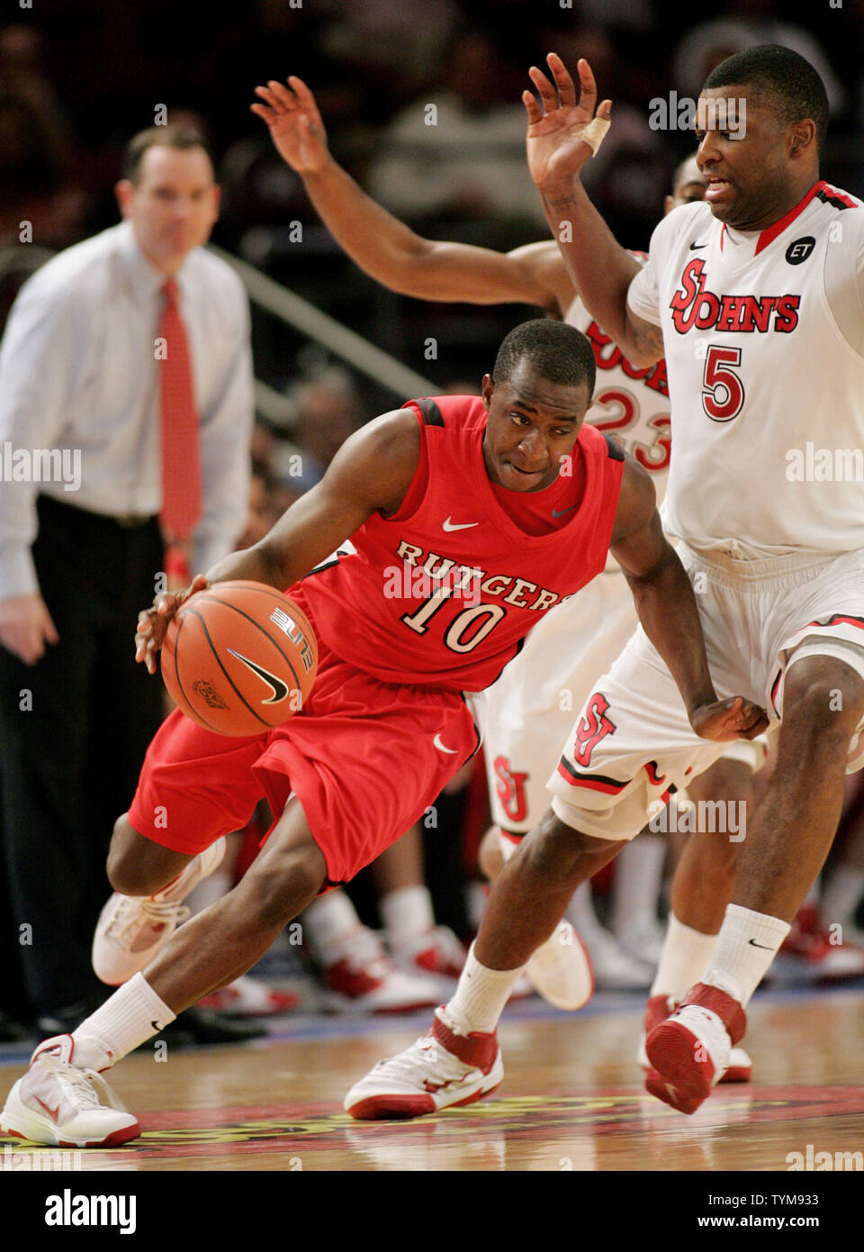 James Beatty of Rutgers drives the ball past Sean Evans of St. John's ...