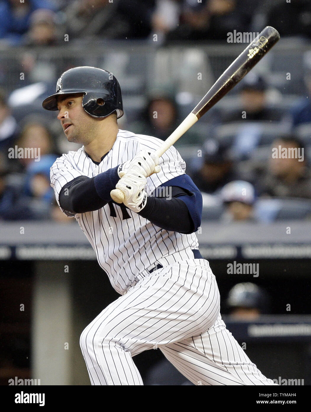 New York Yankees Nick Swisher hits a double in the third inning against ...