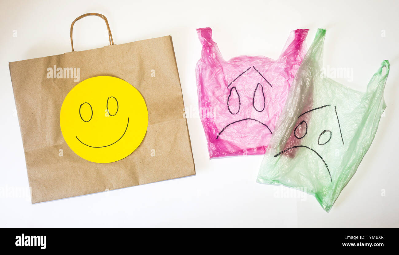 Plastic and paper bags with happy and sad emotions on faces against ...