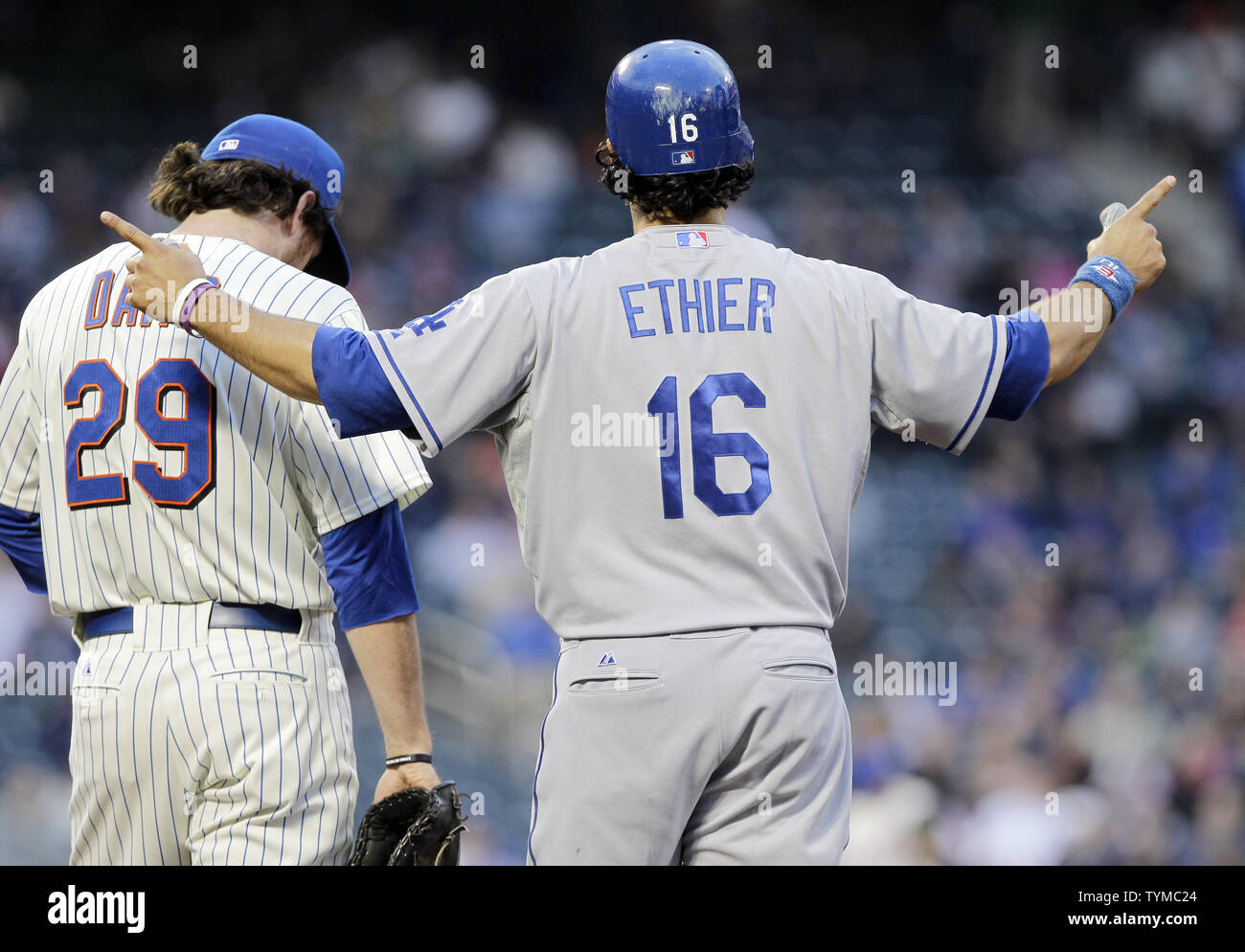 Los Angeles Dodgers Andre Ethier stands on first base while standing next to New York Mets Ike ...