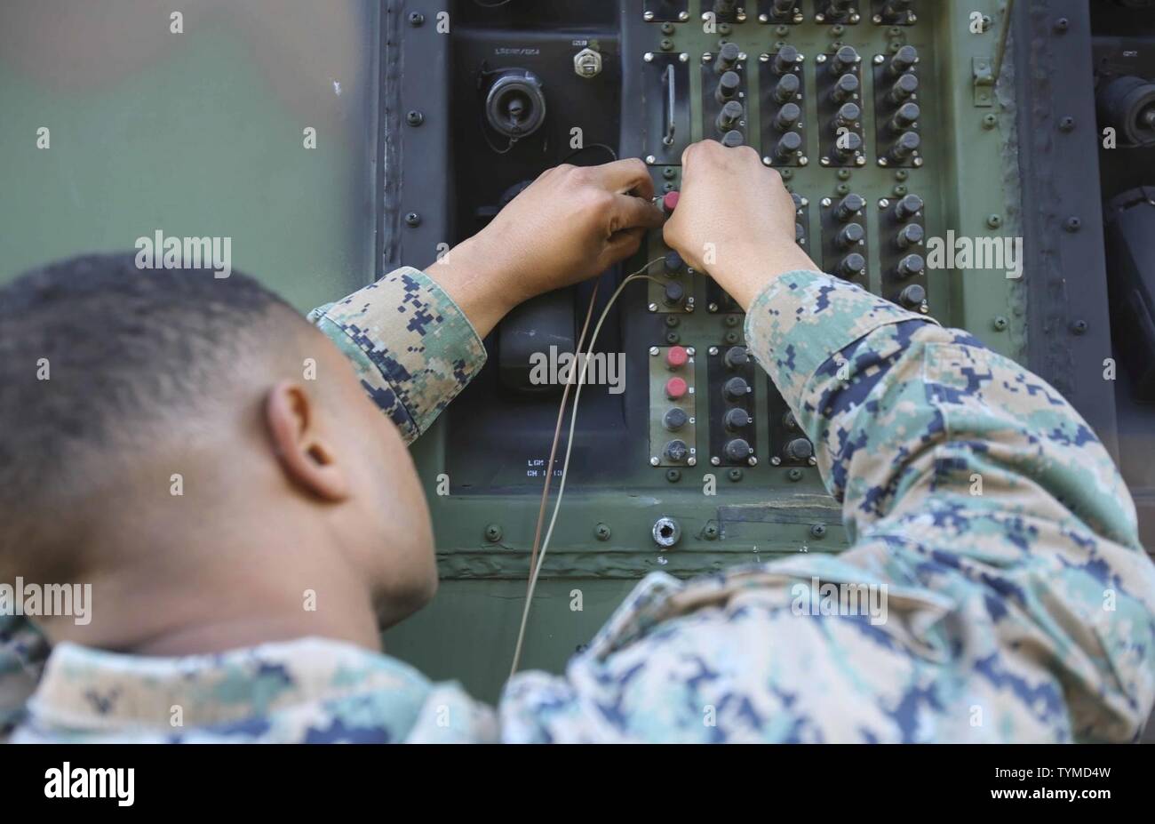 Lance Cpl. Quentin McKnight fastens slash wire to the control panel of ...