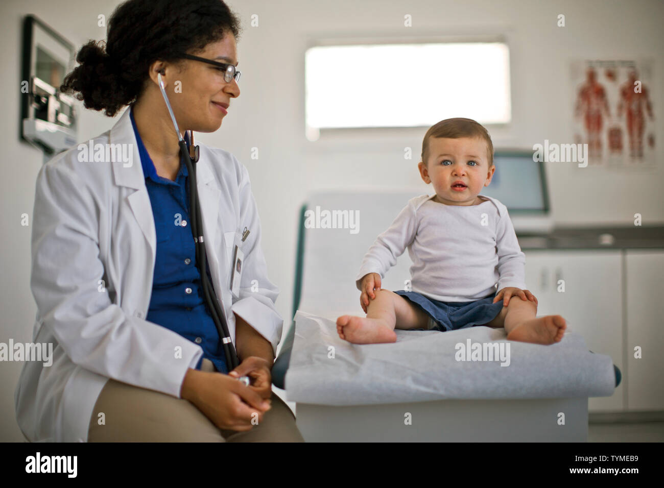 Doctor giving a baby boy a medical check up Stock Photo - Alamy