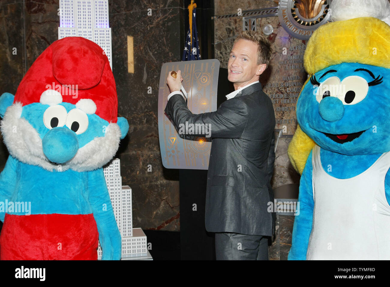 Neil Patrick Harris throws a switch which lights a model of the Empire ...