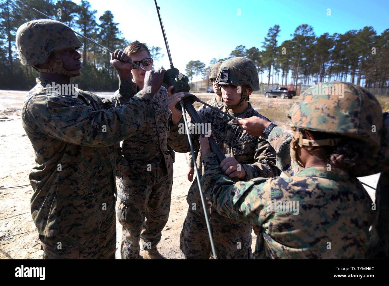 Marines and Sailors worth together to complete the radio OE-254/GRC ...