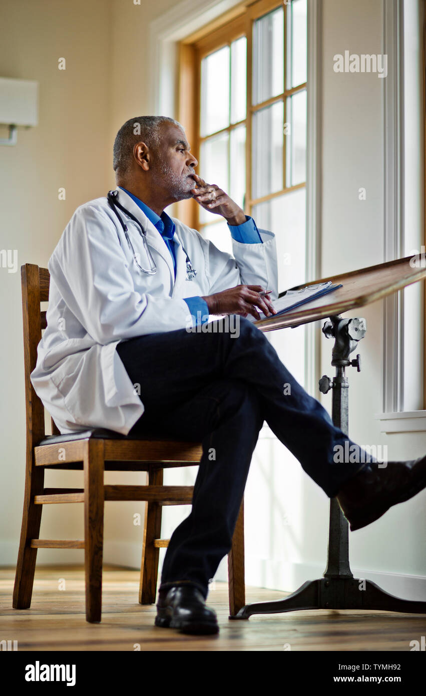 Doctor sitting and thinking Stock Photo - Alamy