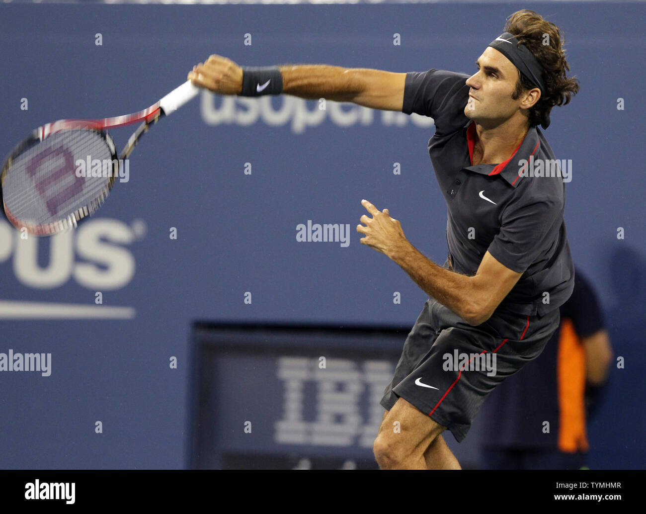 Roger Federer of Switzerland serves to Jo-Wilfried Tsonga of France in their quarterfinal match ...