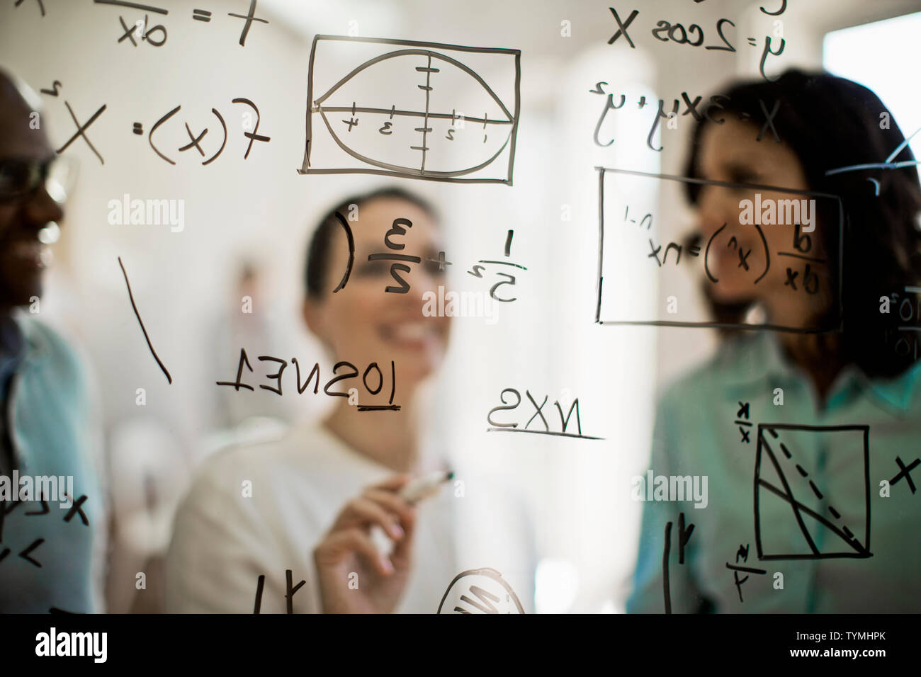 Mathmeticians working to solve equation Stock Photo - Alamy