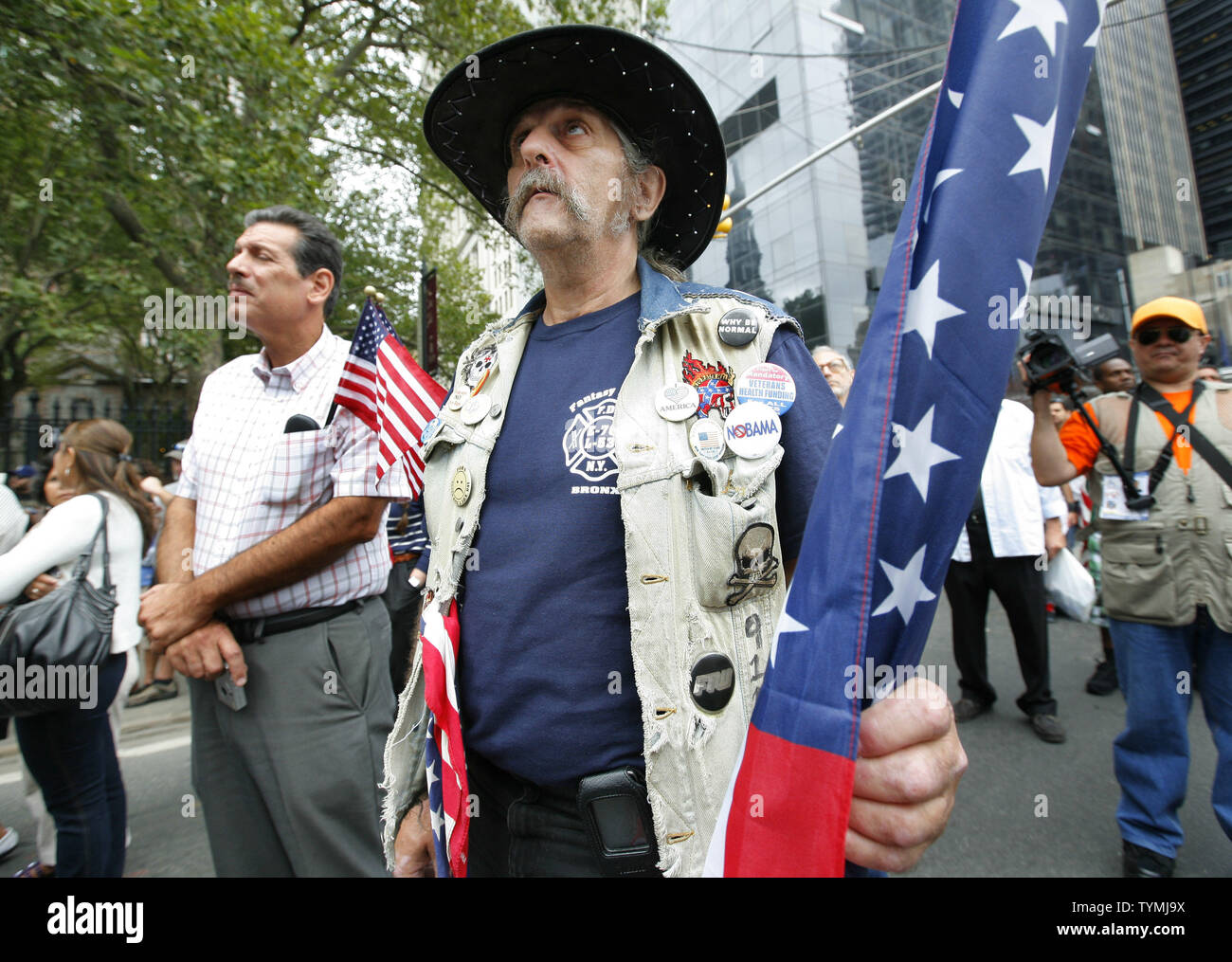 Gary Nielson(R) of the Bronx listens to the reading of the names of ...