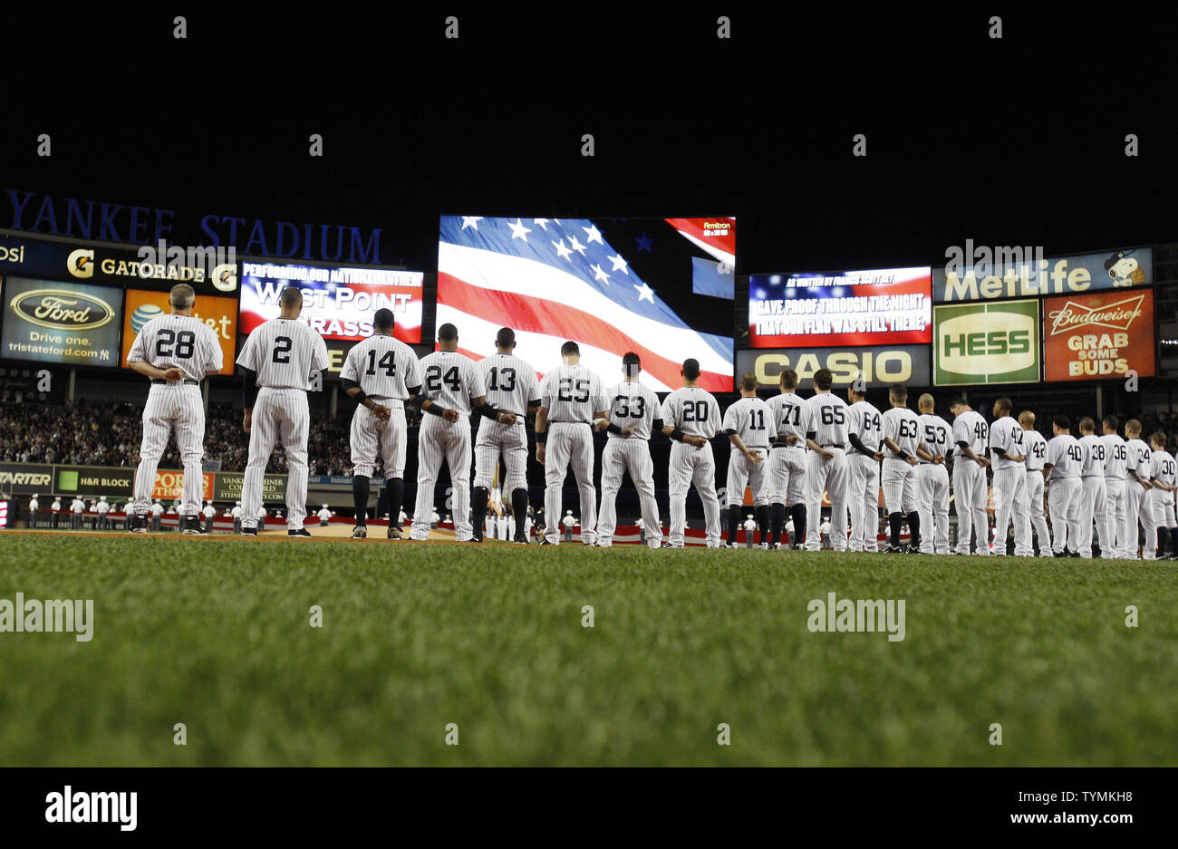 New York Yankees stand on the first base line for the National Anthem ...