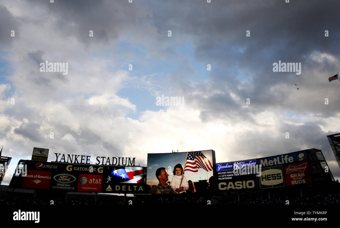 Rain clouds hang over Yankee Stadium for the National Anthem in the ...
