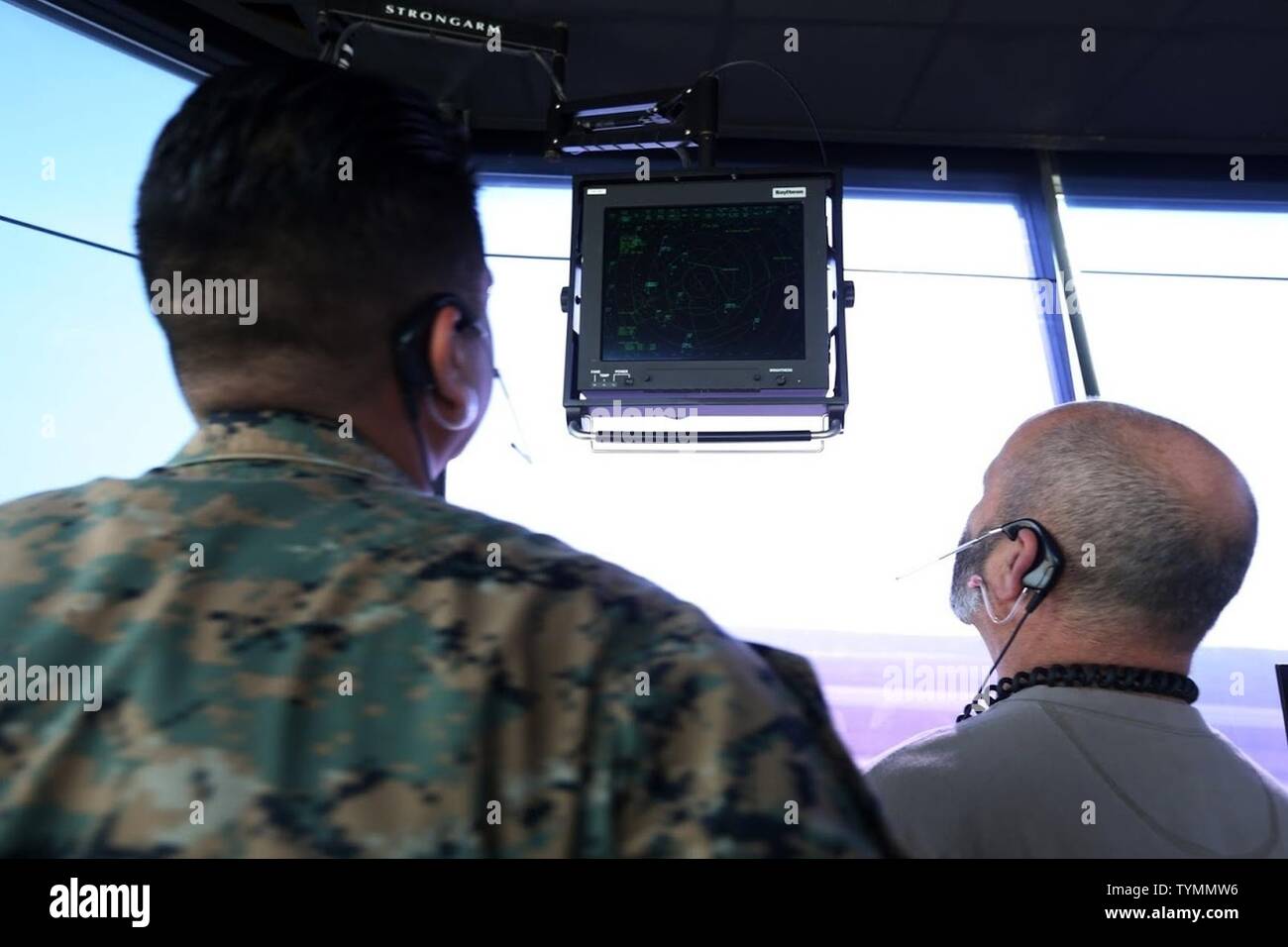 Sgt. Benjamin Bonilla observes a monitor in the control tower at Marine ...