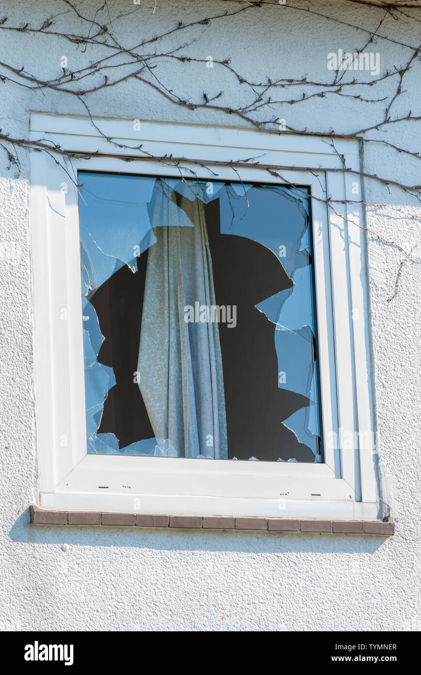 window with cracked glass after stone throw vandalism Stock Photo - Alamy