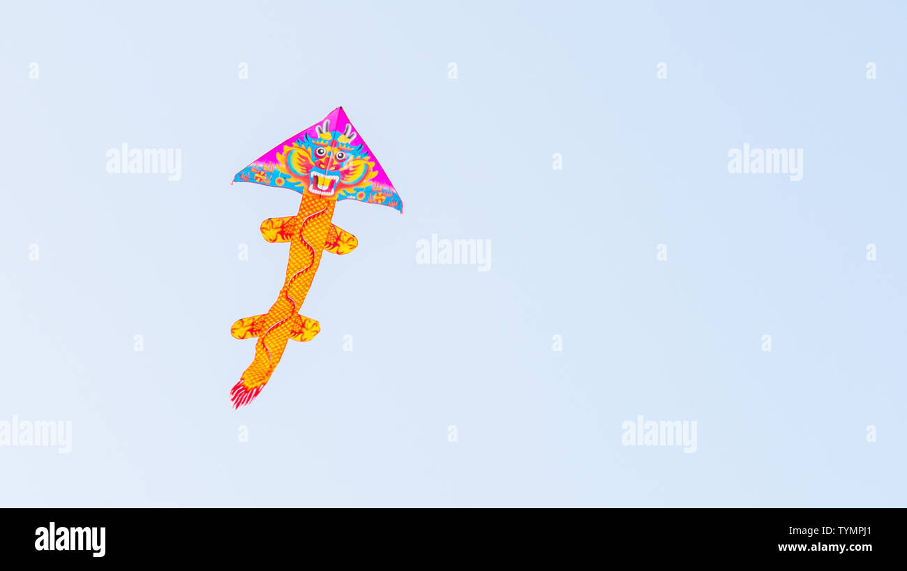 Colorful kite flying in blue sky Stock Photo - Alamy