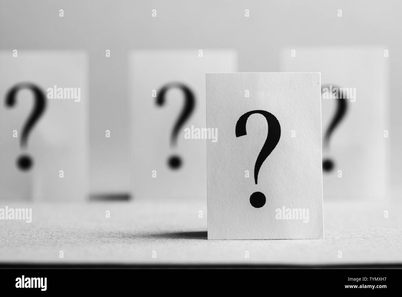 Four question mark cards stood on white background Stock Photo - Alamy