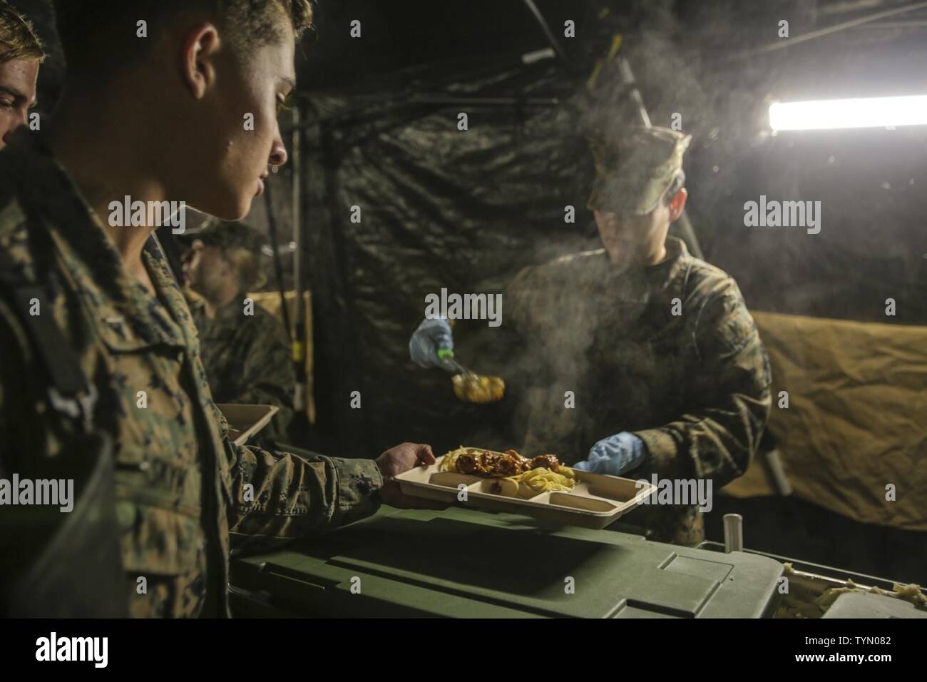 Marines prepare and serve food to the Marines and sailors participating ...