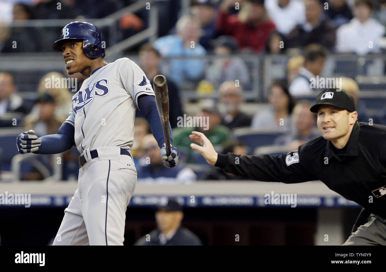 Home Plate Umpire Mike Estabrook and Tampa Bay Rays B.J. Upton watch a ...
