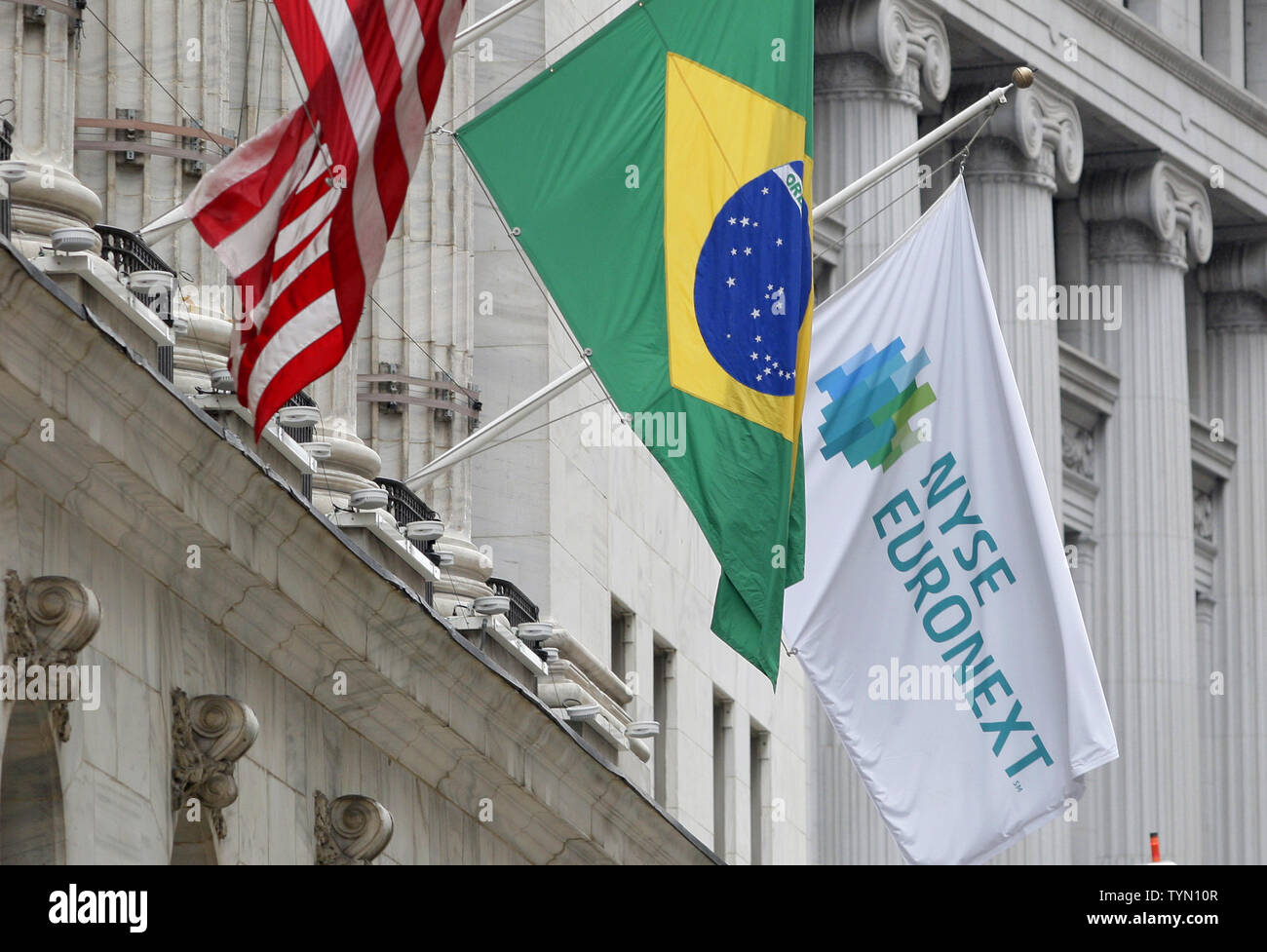 A flag with the new NYSE logo hangs outside of the NYSE before the ...