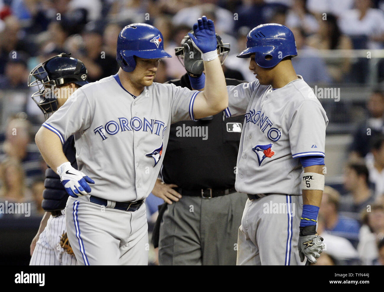 Toronto Blue Jays Adam Lind reacts with Yunel Escobar after he hits a ...