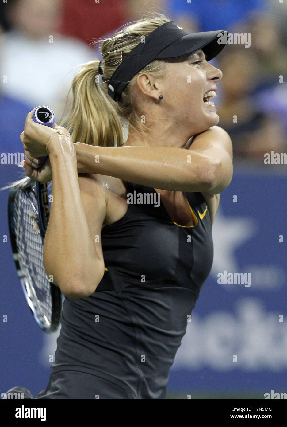Maria Sharapova of Russia hits a backhand in her second round match ...