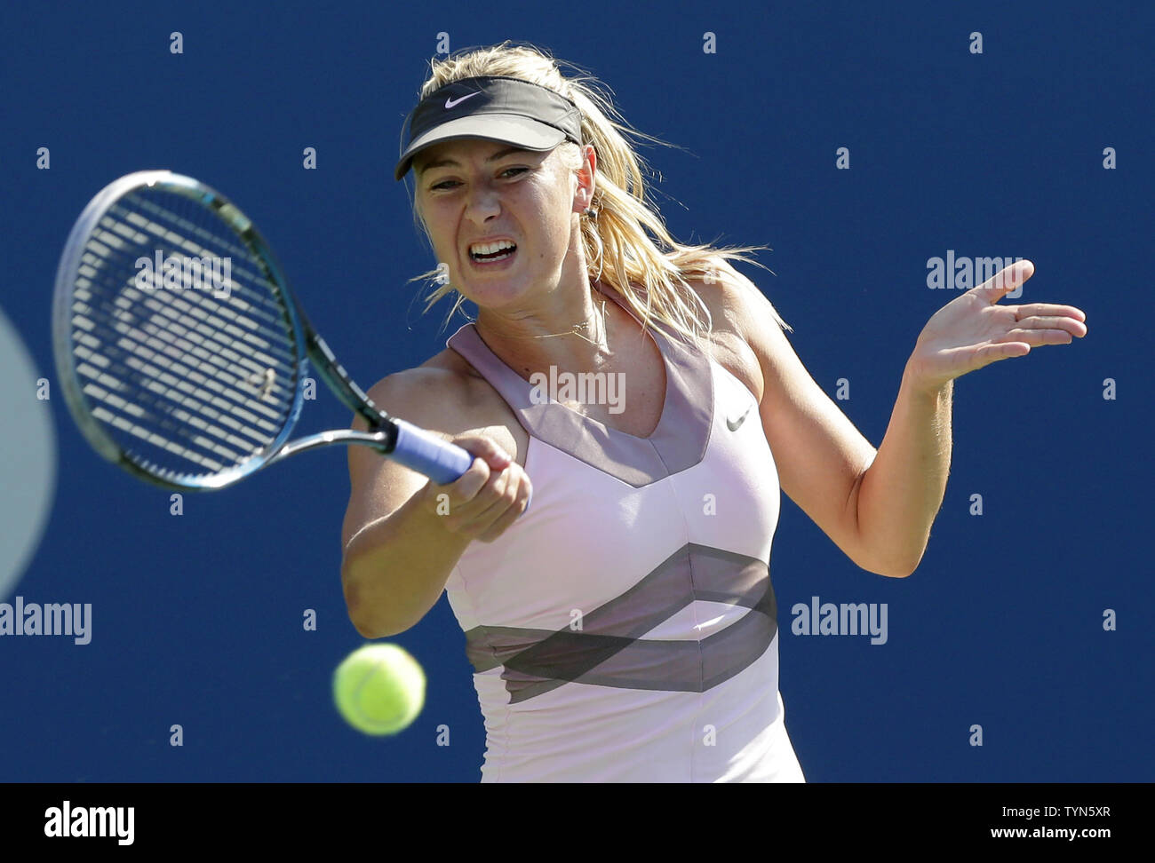 Maria Sharapova of Russia hits a forehand in her match against Mallory ...
