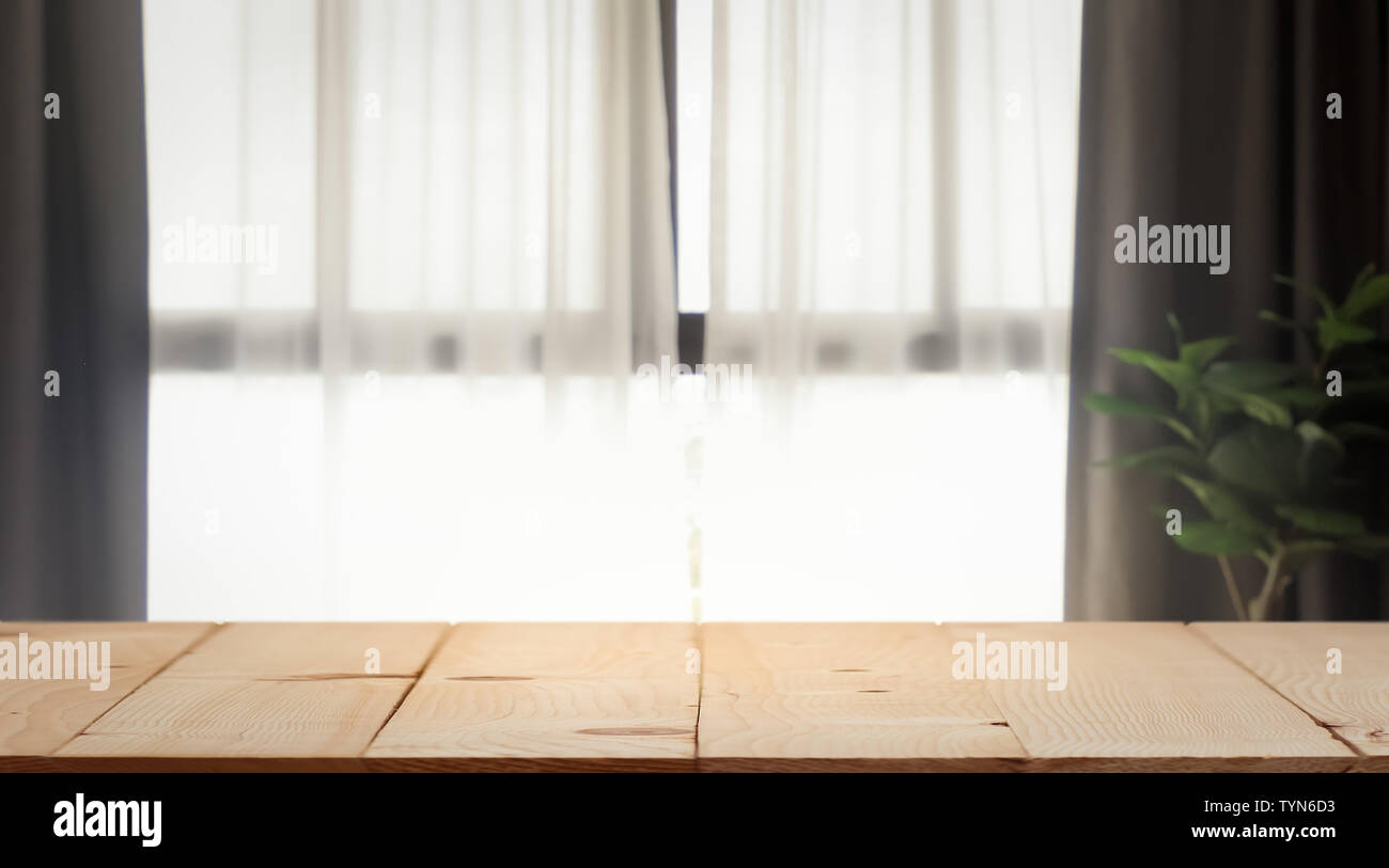 Wooden table on Defocused bedroom and curtain window with sunlight in ...
