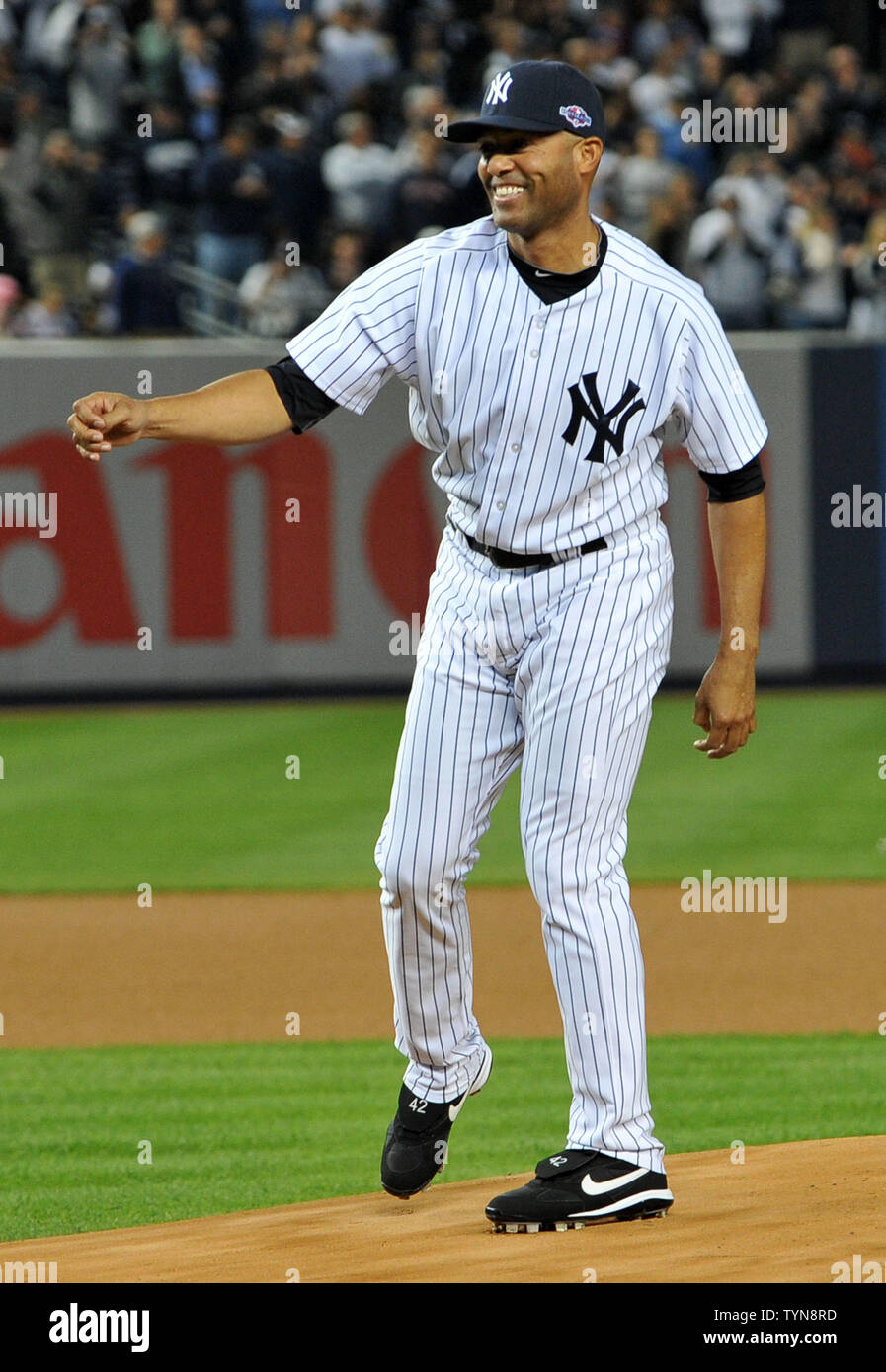 New York Yankees relief pitcher Mariano Rivera smiles after he throws ...