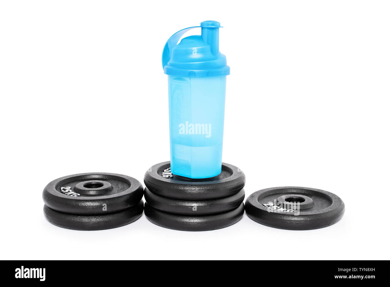 Protein shaker on a pedestal of weight plates, isolated on a white ...