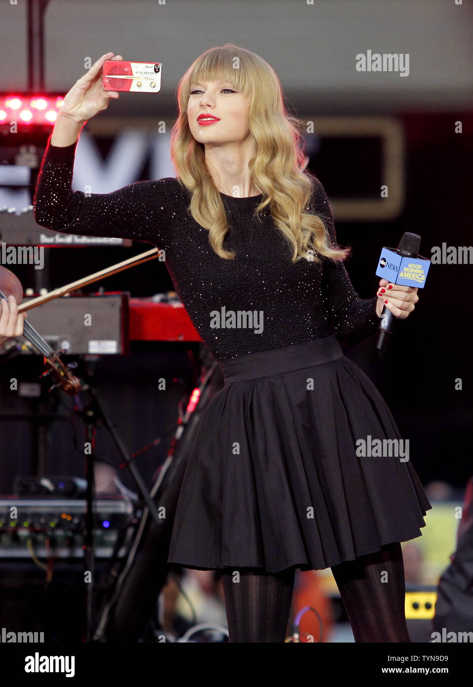Taylor Swift performs takes a picture of the audience with her phone ...
